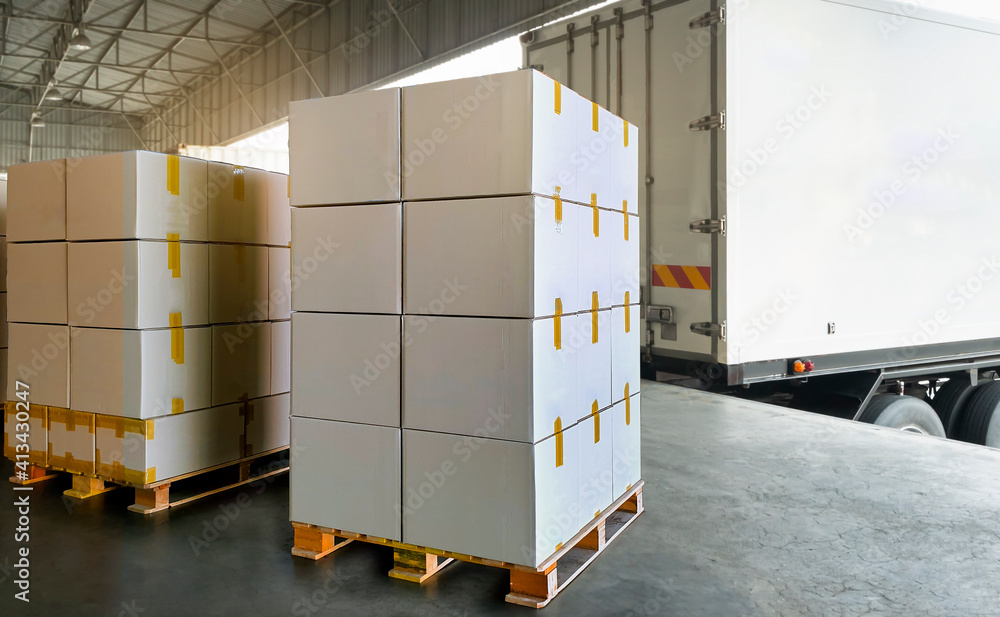 Stack of cardboard boxes on pallet rack load into shipping container ...