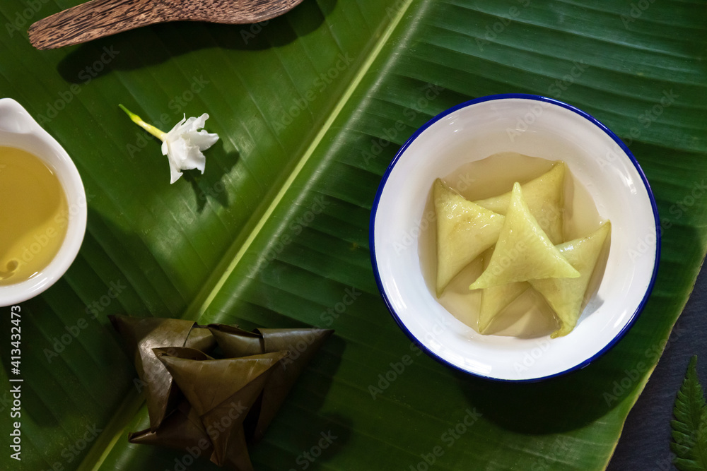 Dessert made with glutinous rice wrapped in banana leaves, triangle ...