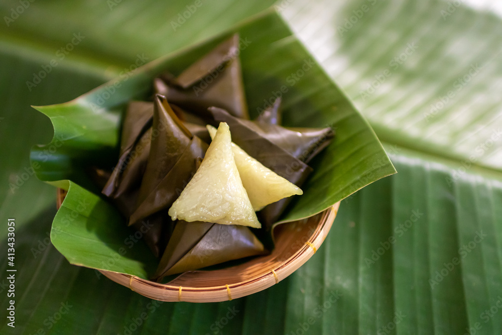 Dessert made with glutinous rice wrapped in banana leaves, triangle ...