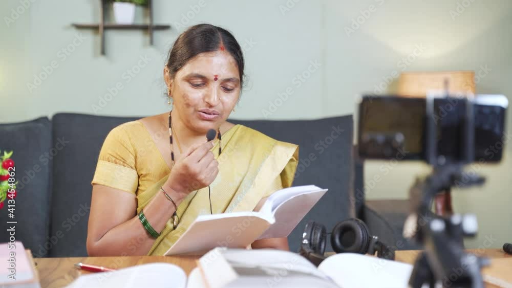 Indian woman busy explaining to students in front of mobile during ...