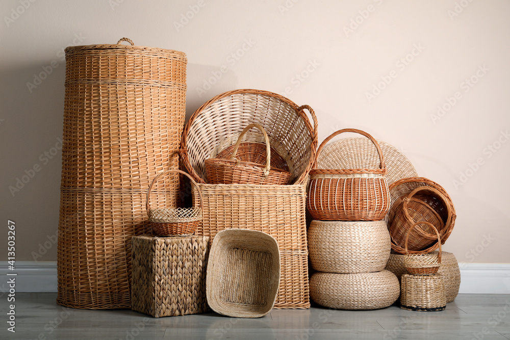 Many different wicker baskets made of natural material on floor near ...