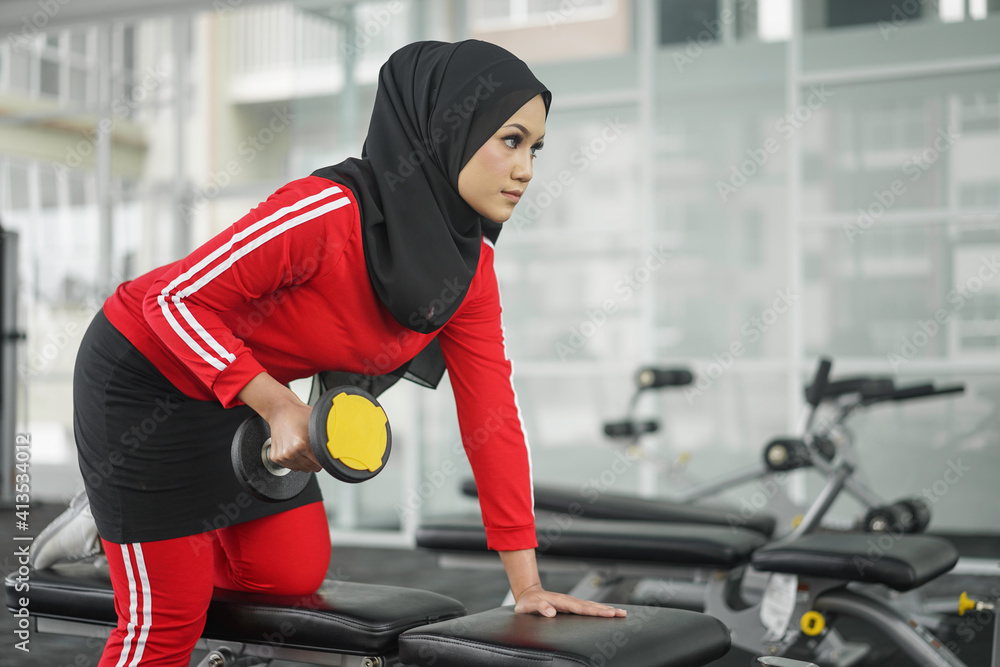 Portrait of attractive young Muslim woman workout in gym healthy ...