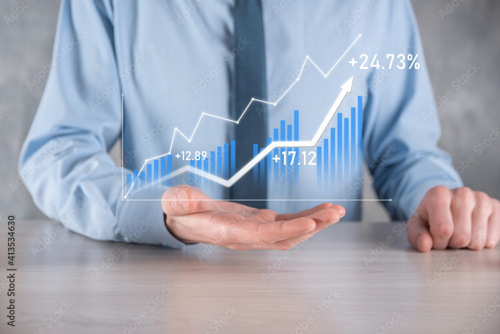 Businessman man holding a graph with positive profits growth. plan ...