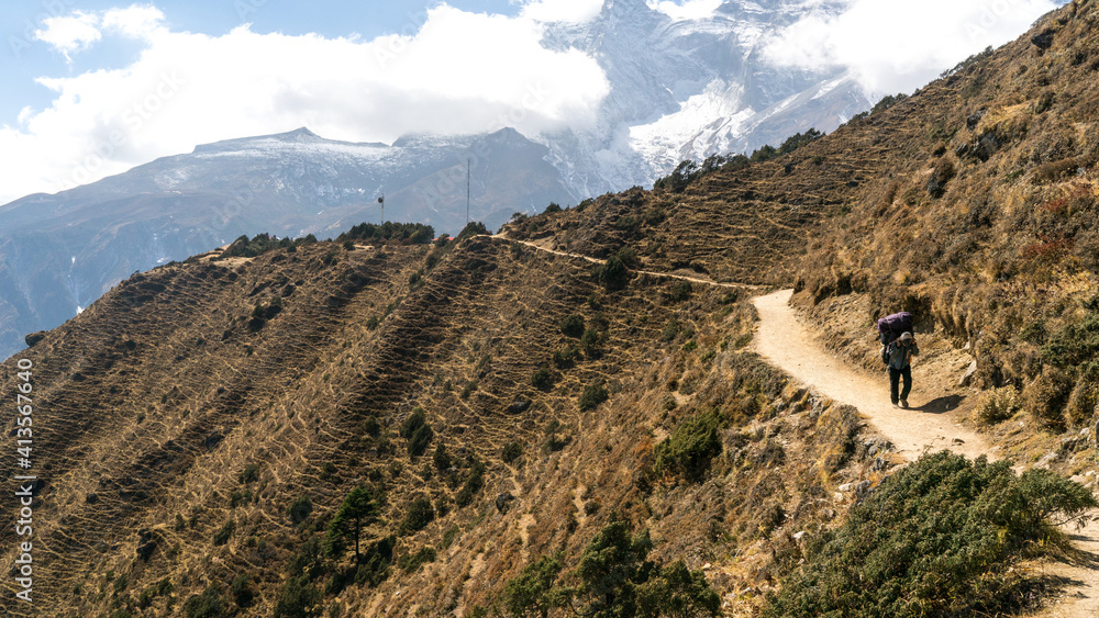 sherpa carrying luggage, labour work of sherpas, landscape in the ...