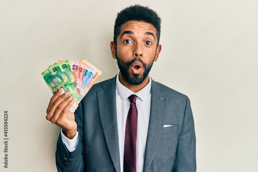 Handsome hispanic business man with beard holding south african rand ...