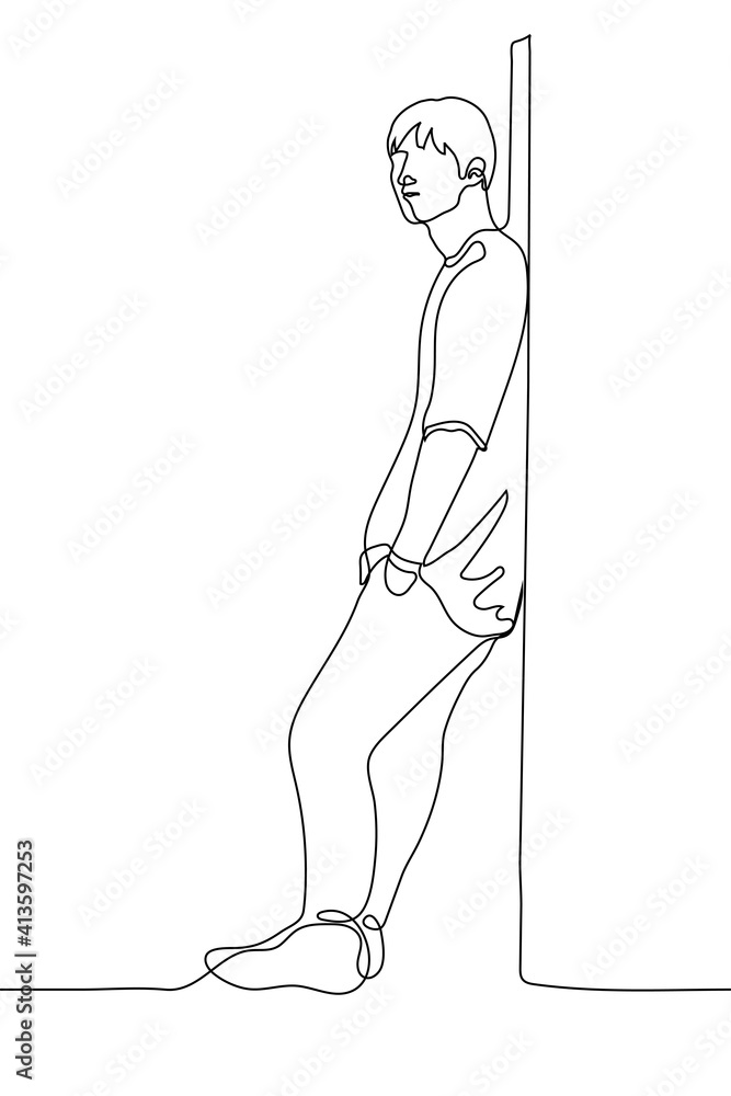 short-haired man in a T-shirt and pants stands with his back against ...