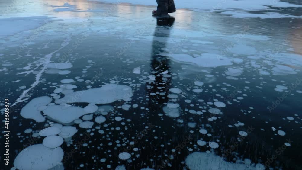 Methane bubbles frozen in Arctic lake surface ice - Climate change ...