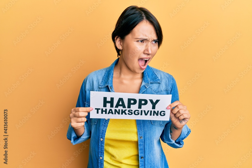 Beautiful young woman with short hair holding happy thanksgiving ...
