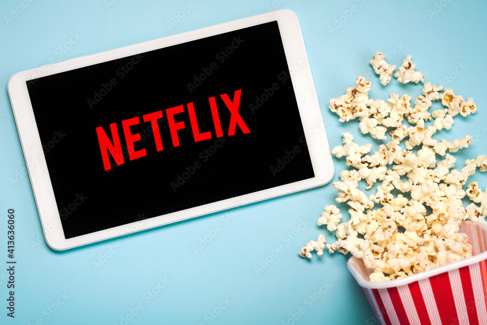 Netflix logo on the screen of a white digital tablet with popcorn Stock ...