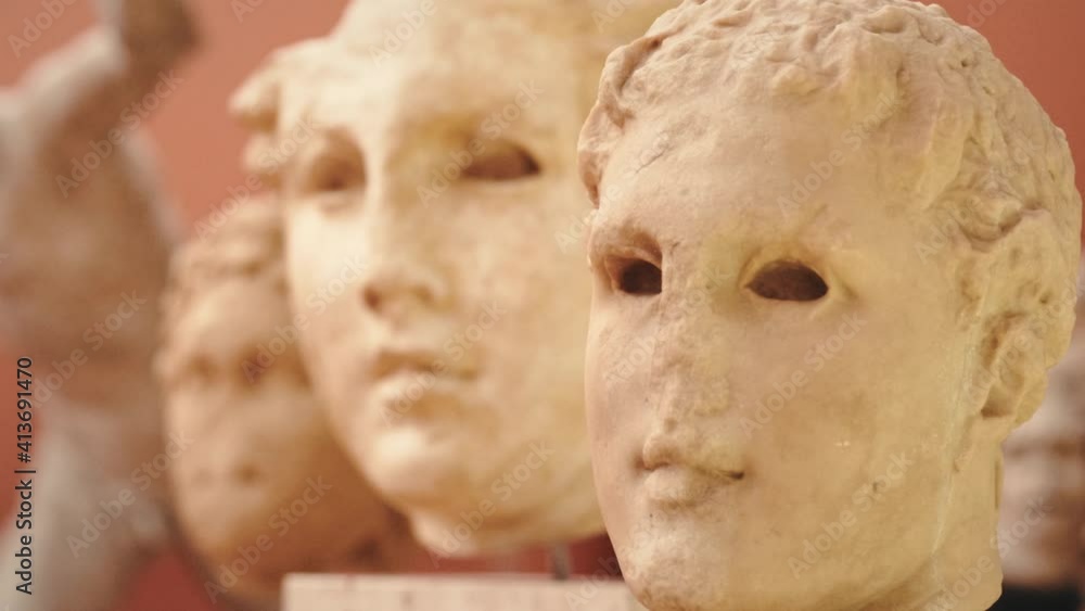 Close up of three ancient antique male statue heads in a museum with ...