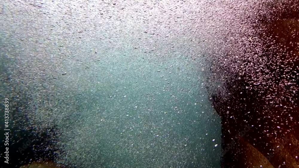 Water churned boils and bubbles underwater of fast flowing waters of ...