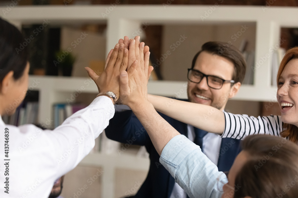 Close up crop of smiling multiracial colleagues coworkers celebrate ...