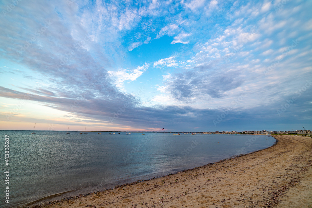 Beautiful sunset sky colors and clouds above the beach shoreline. Stock ...