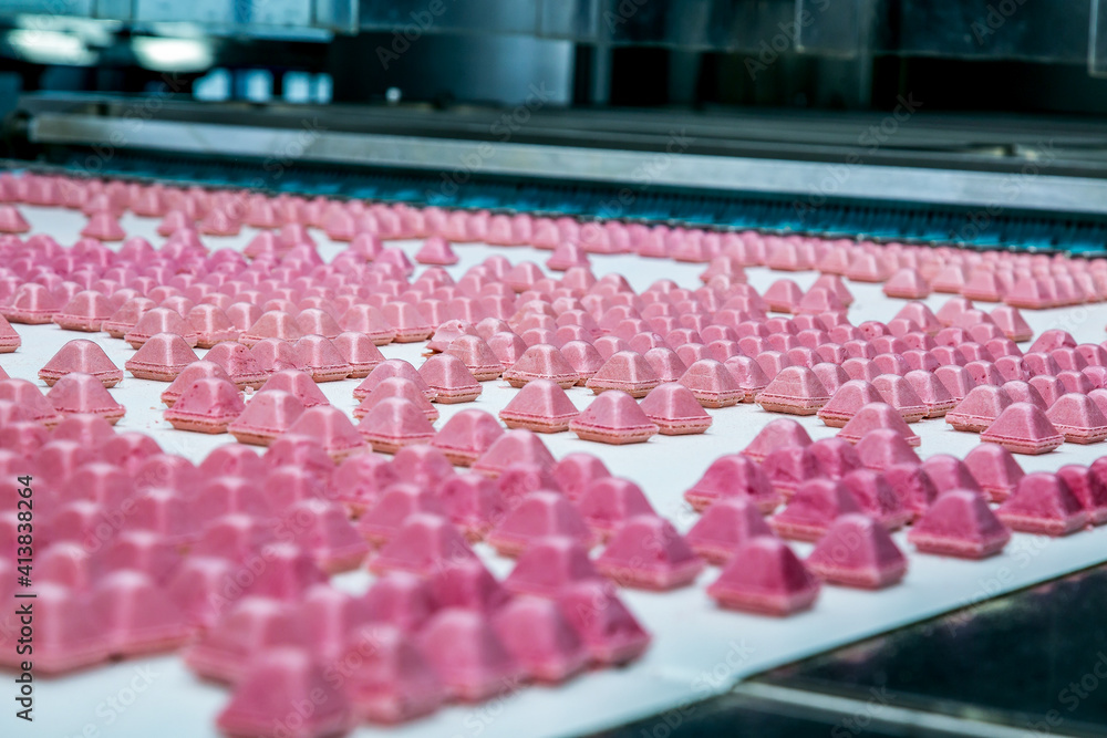 Sweets factory. Sweets production process. Conveyor belt with sweets on ...