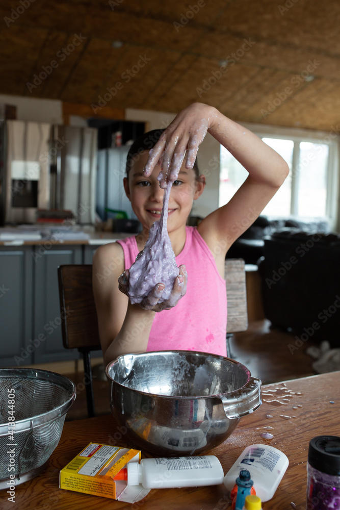 Girl stretching slime she made with her hands Stock Photo | Adobe Stock