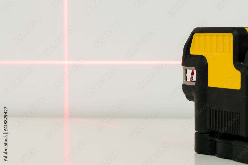 Electronic laser pointing straight lines. Checking angles and setting ...