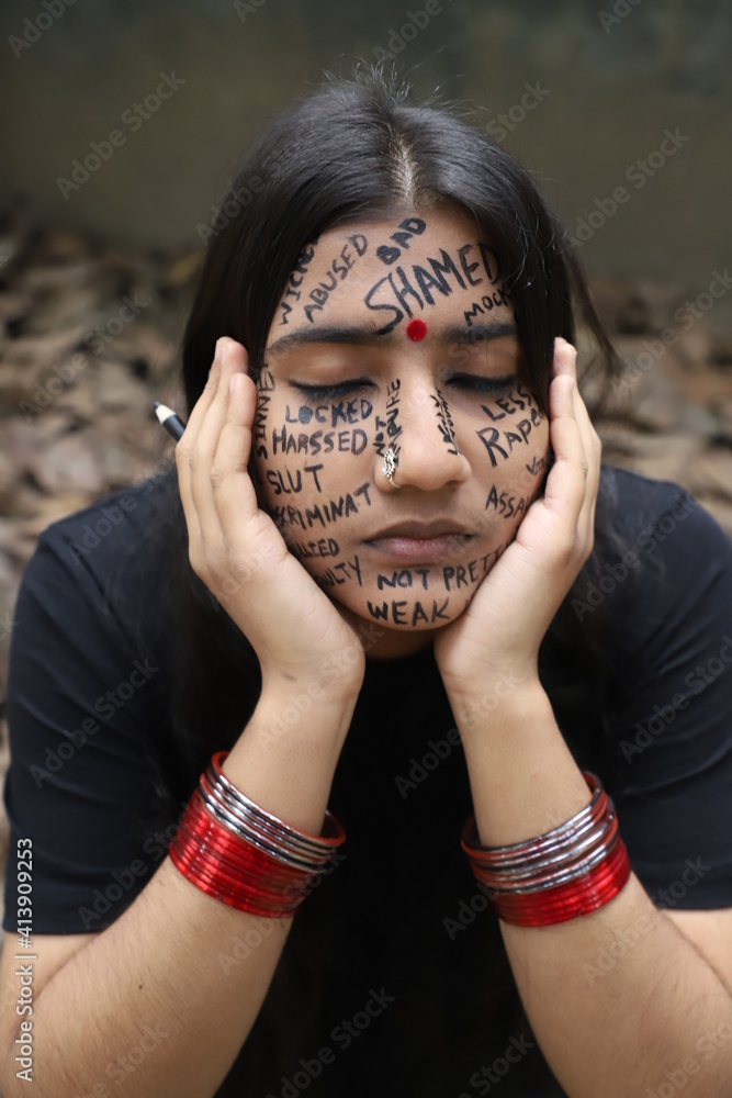 A southeast Asian brown woman protesting gender based violence by ...