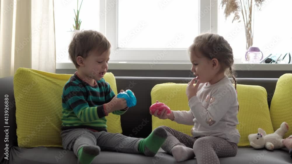authentic baby hands with blue and red slime. Girl and boy preschool ...