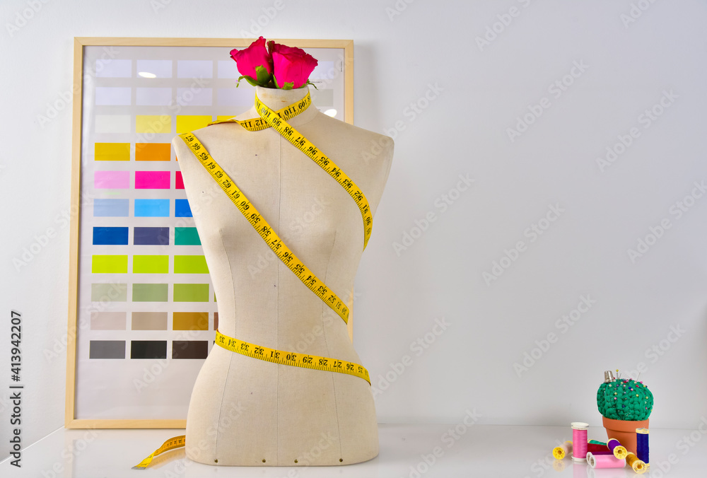 Beige sewing mannequin, on white brick background, white floor, with ...