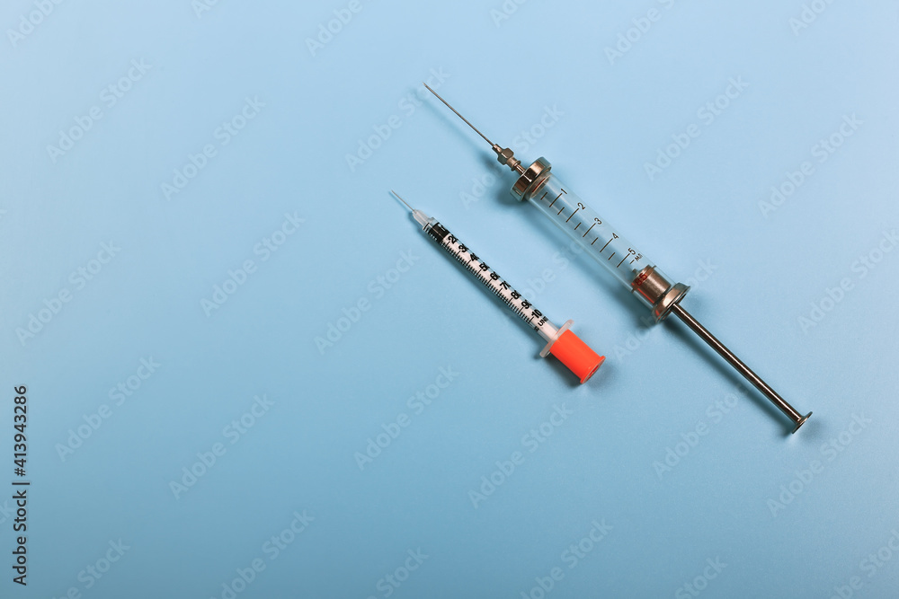 Medical concept. Two syringes for injections on a blue background ...