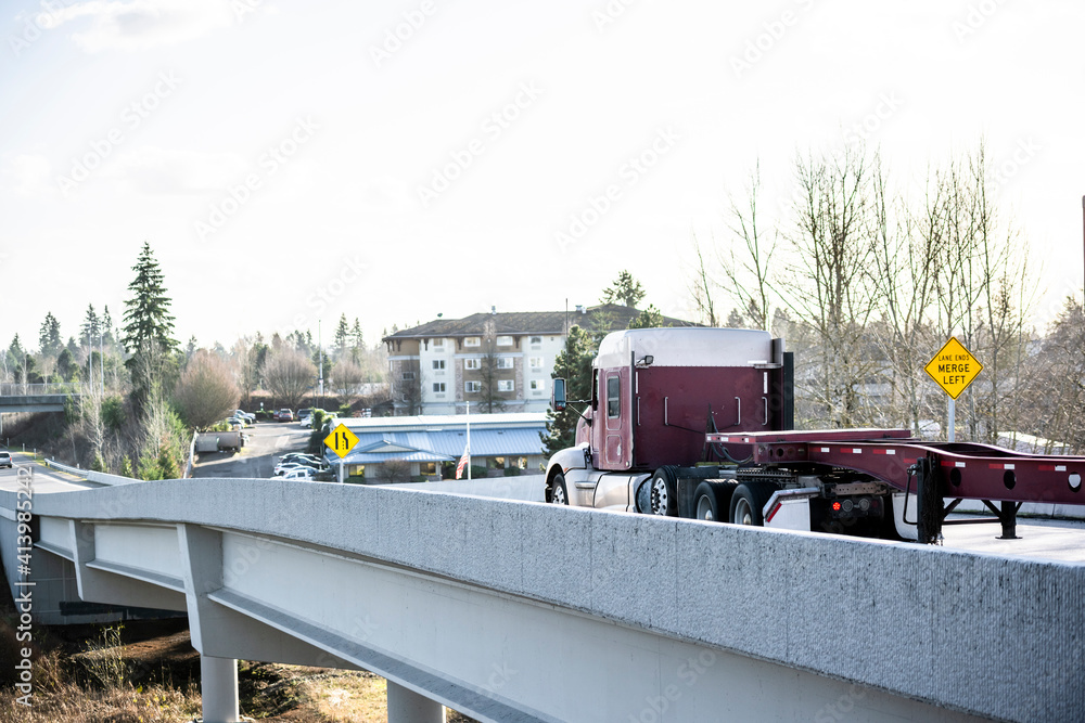 Dark red and white big rig powerful semi truck tractor with step down ...