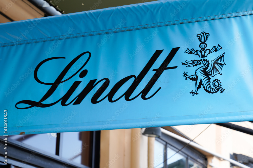 Lindt logo text and brand sign shop flag front of store wall of Swiss ...