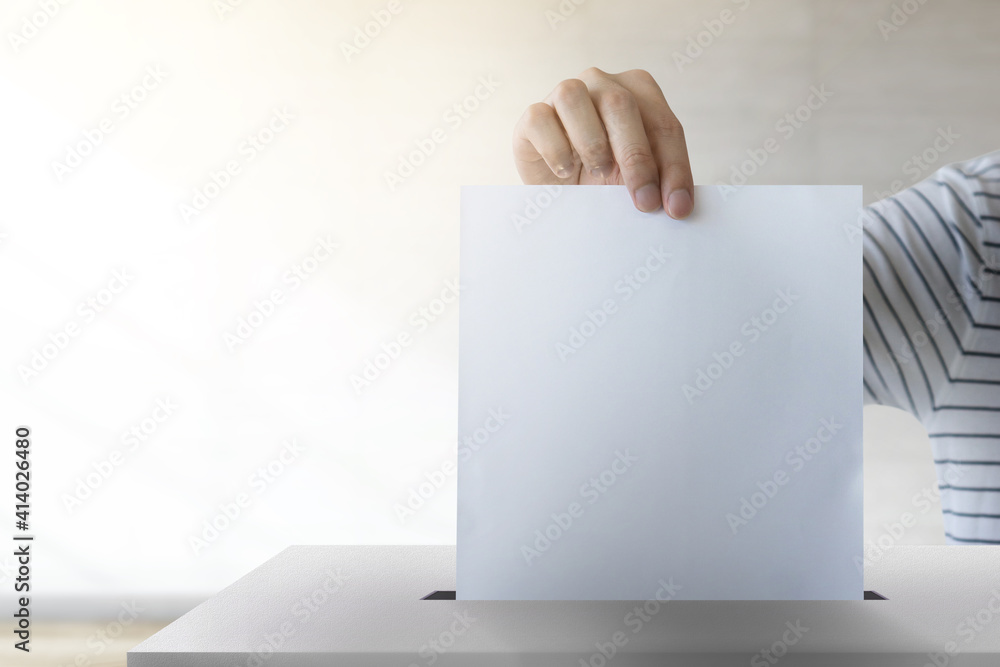 Hand holding big ballot paper for election vote concept at room ...