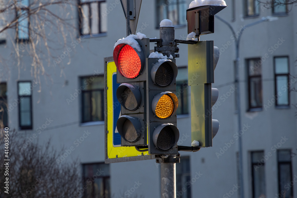 traffic lights with a red traffic signal on the street of the city ...