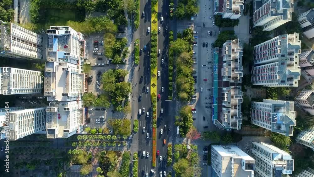 Drone shot of the bustling city along urban highways; high-rise ...