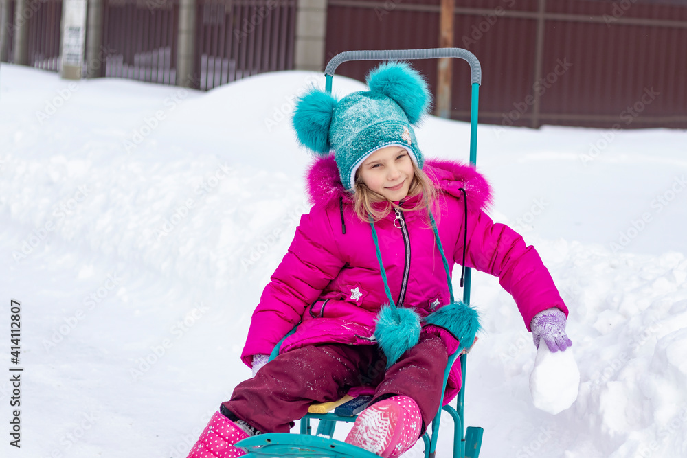 Street lighting. winter is a lot of snow. a beautiful girl in a red ...