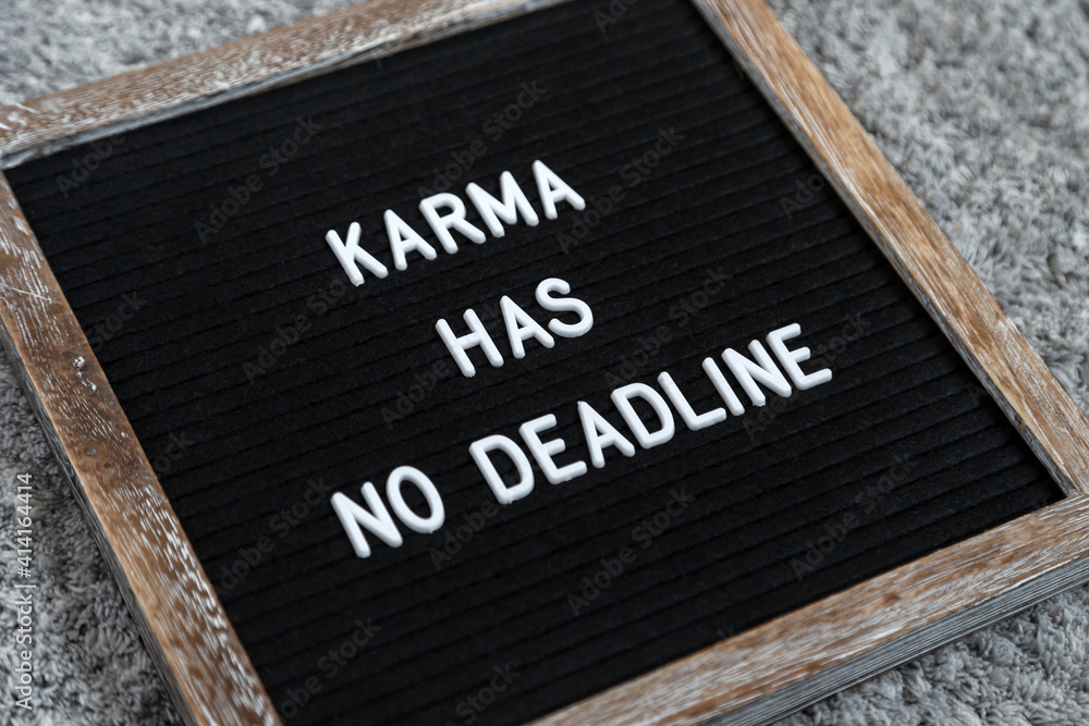Felt letter board sign "Karma has no deadline" in a wooden frame on ...