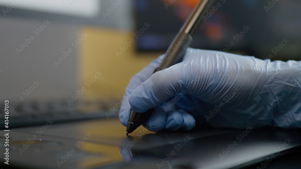 Using tablet with surgical gloves during Coronavirus lockdown. rubber ...
