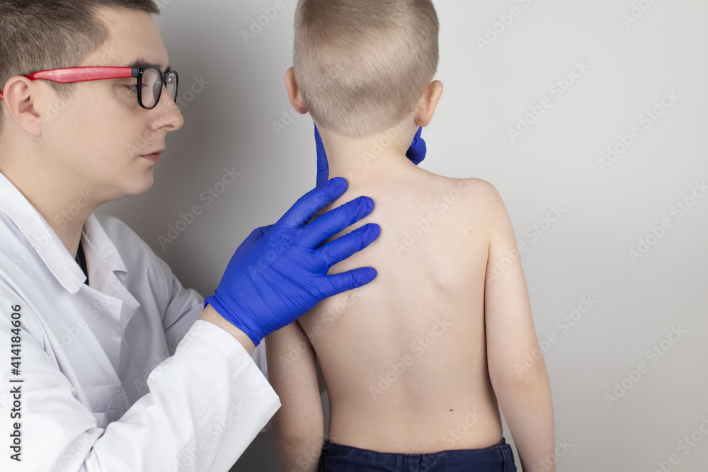 A little boy at the doctor's appointment with back pain. Treatment of ...
