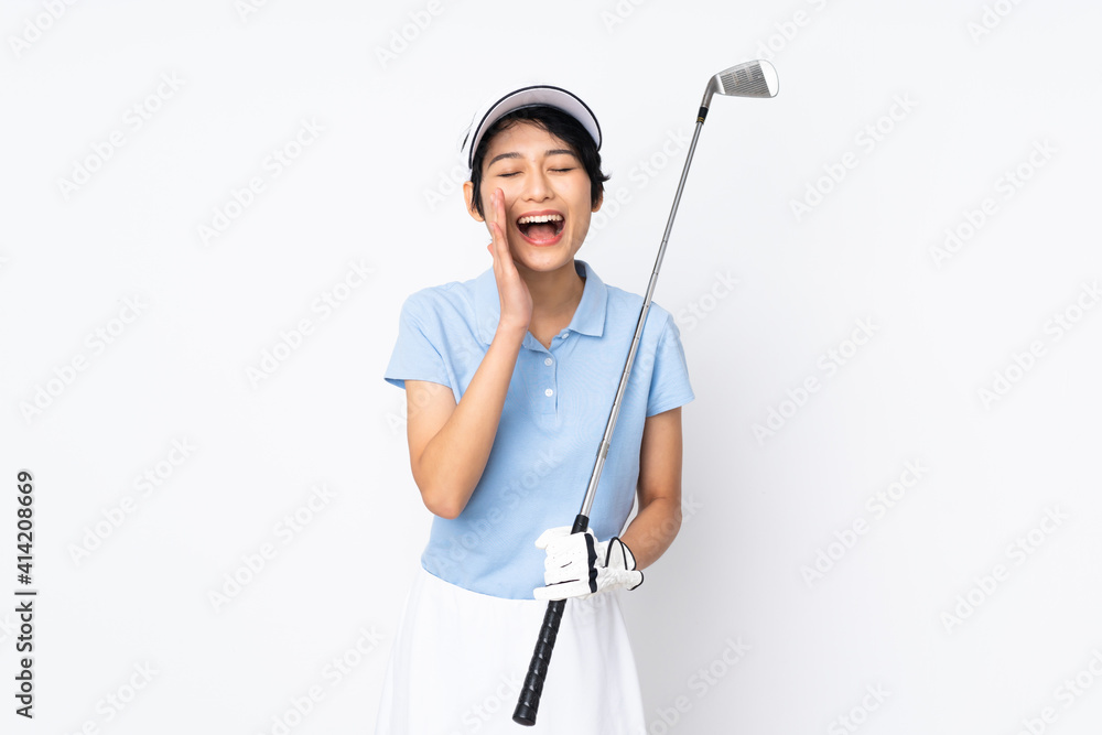 Young Vietnamese golfer woman over isolated white wall shouting with ...