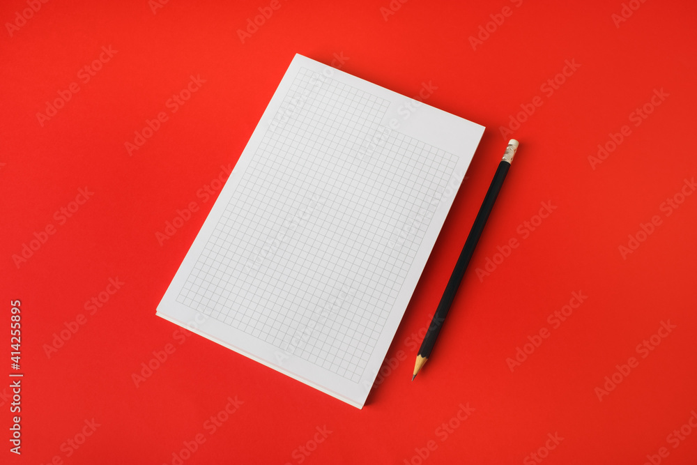 Blank stationery mockup. Blank copybook and pencil on red paper ...