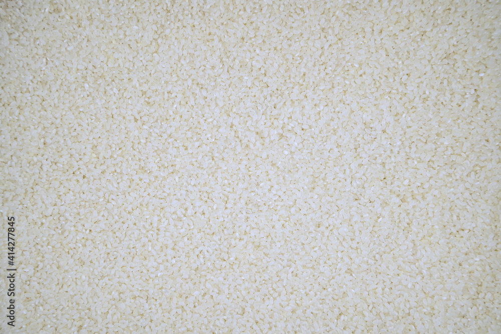 Uncooked rice texture background, peeled grains and agricultural ...