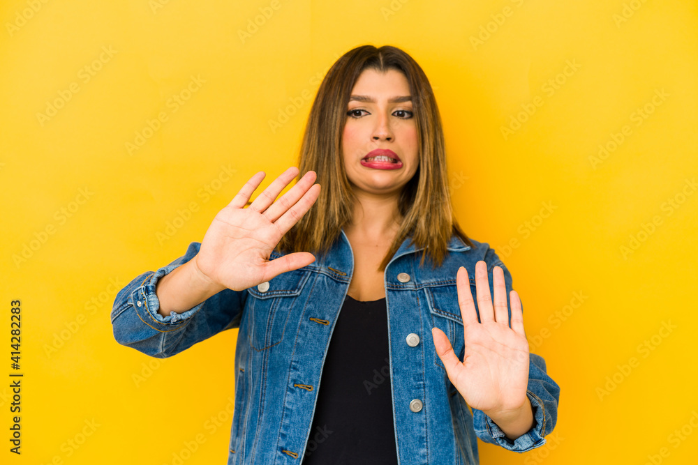 Young indian woman isolated on yellow background rejecting someone ...