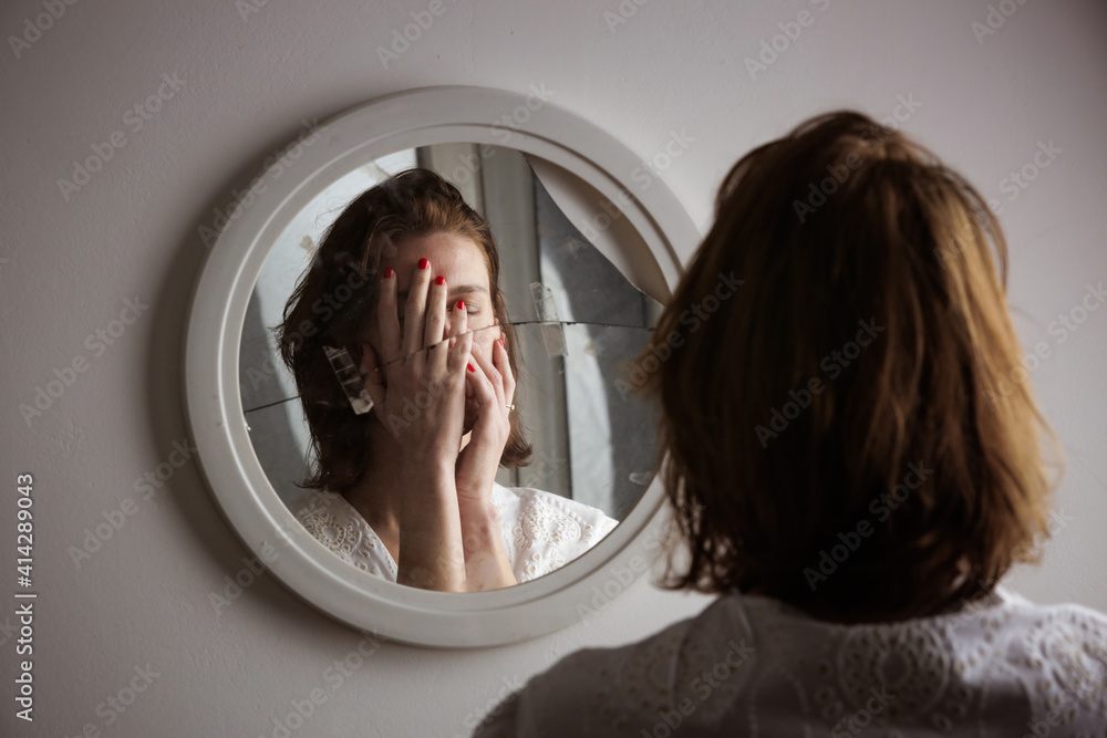Reflection of a woman's face in broken mirror. Depression, anxiety ...