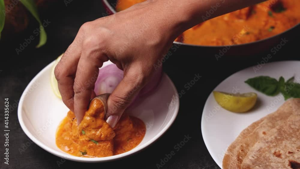 Woman hand eating Paneer butter masala , Paneer tikka masala curry ...