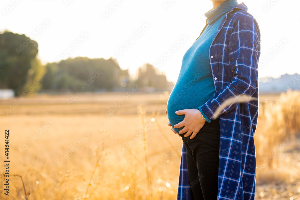 A Japanese woman who is pregnant and close to giving birth. Outside in ...