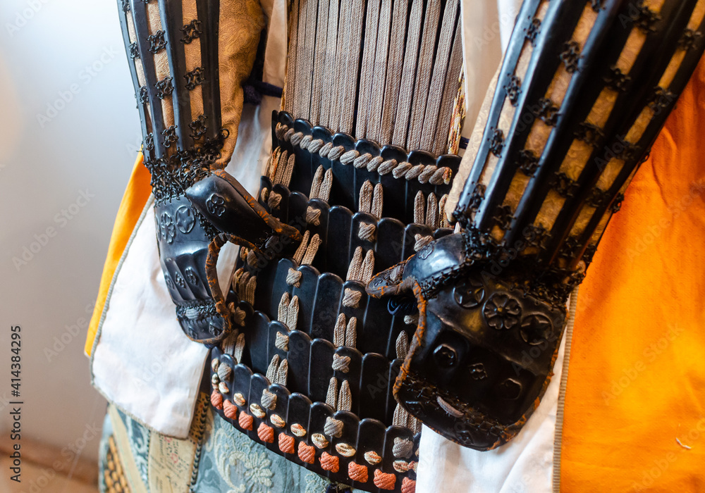 Original medieval japanese samurai armor (yoroi) in the museum. Hands ...