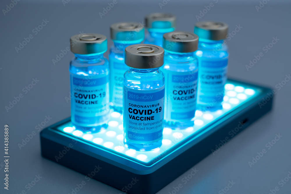 ampoules or vials with Covid-19 vaccine on a laboratory bench. SARS-CoV-2 Vaccination ...