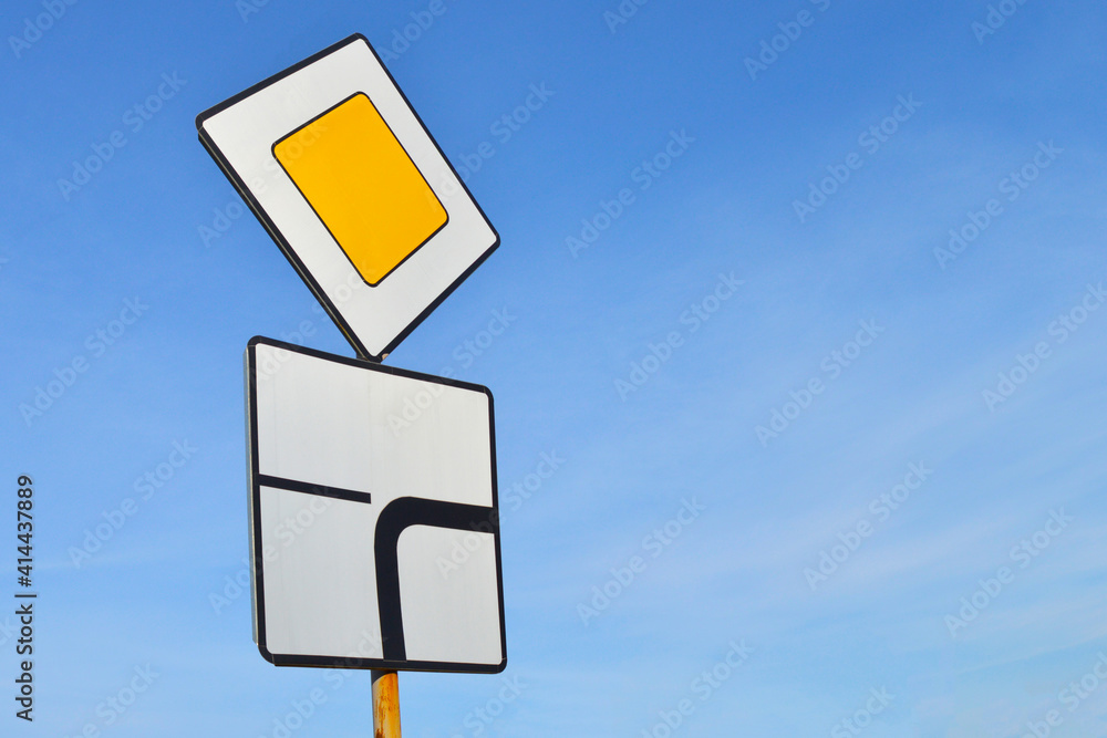 Signpost of the main road and turning. Road sign on a blue sky ...
