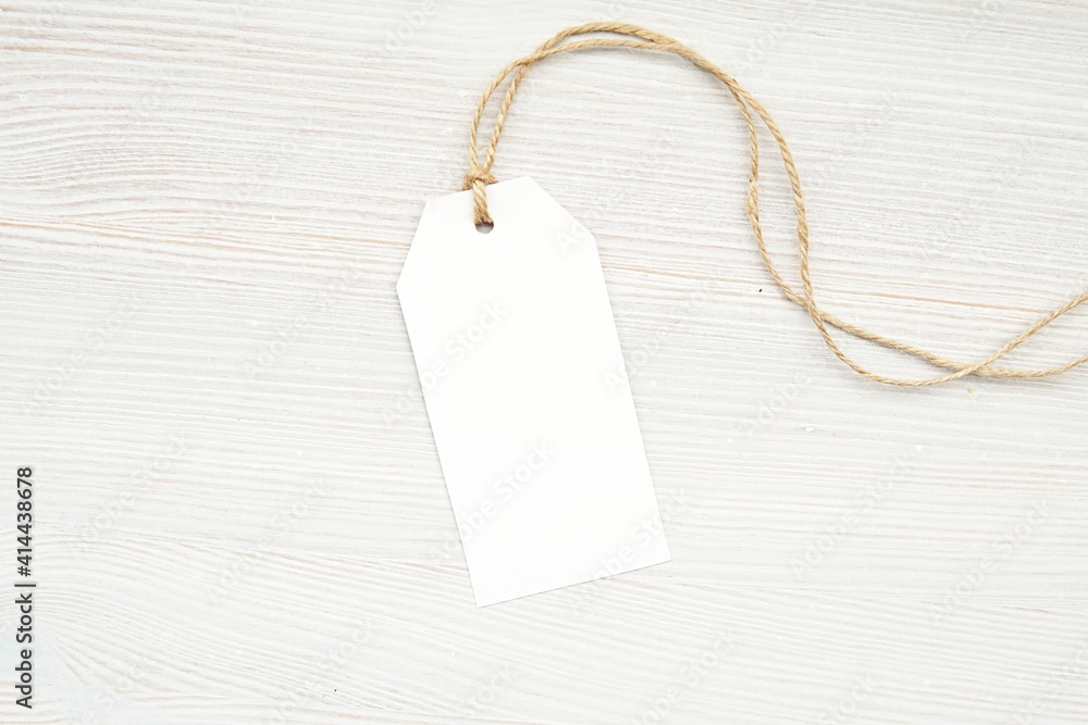 Empty plain rectangle tag mockup on white wooden background for design ...
