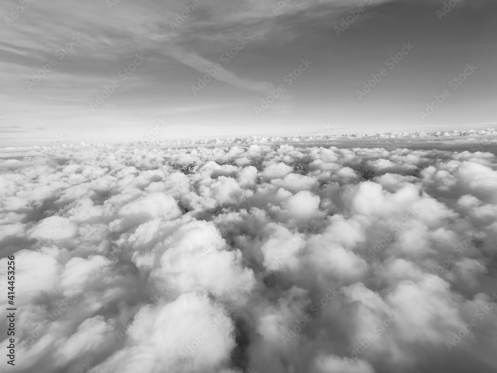 View from the plane to white volumetric thunderclouds and the space of ...