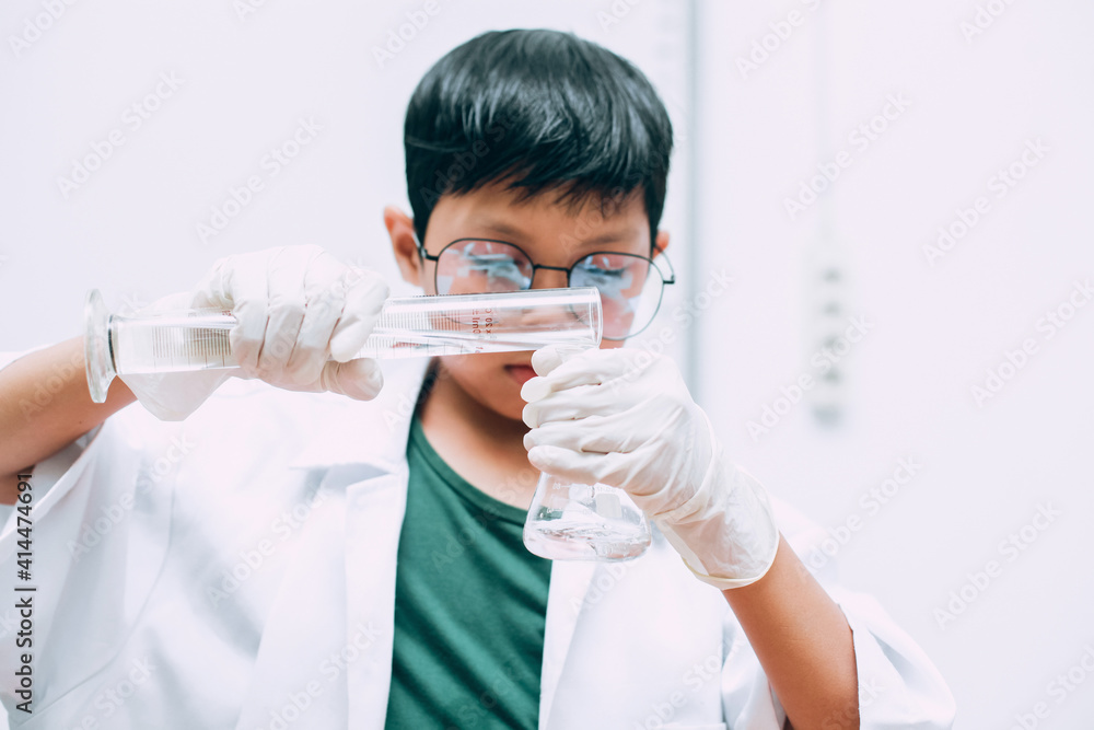 A Student Pouring Liquid in the Beaker. Conducting Experiments in a ...