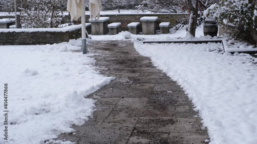 Stockvideo Icy sidewalk covered with gravel for pedestrian safety. Rock ...