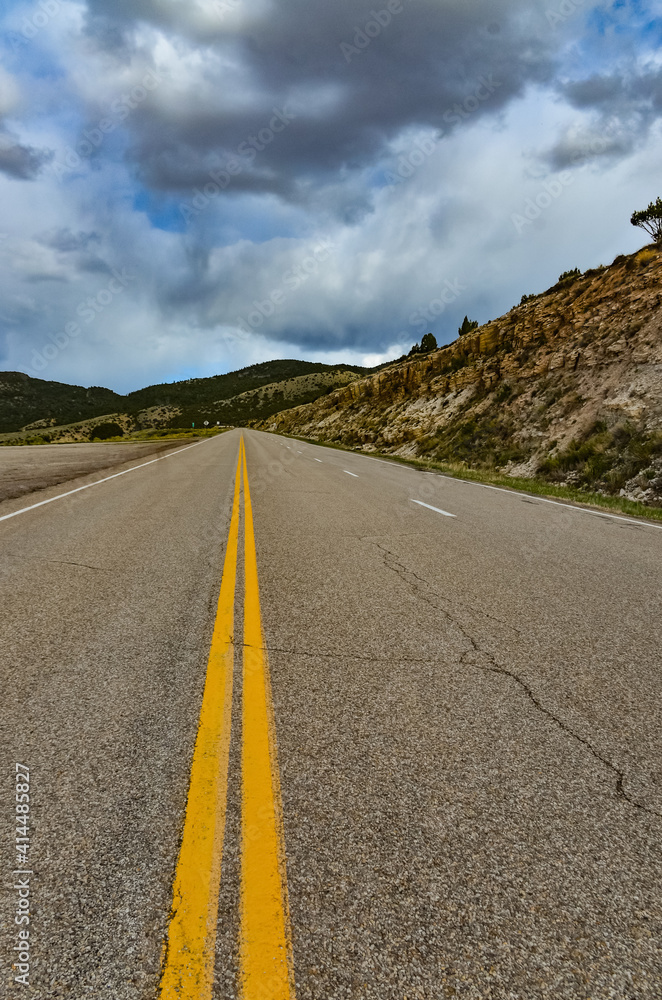 Straight flat asphalt road stretching into the distance beyond the ...
