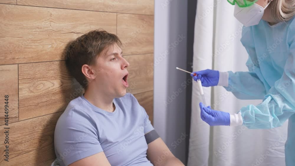 Video „Health professional in PPE suit introducing a nasal and throat ...