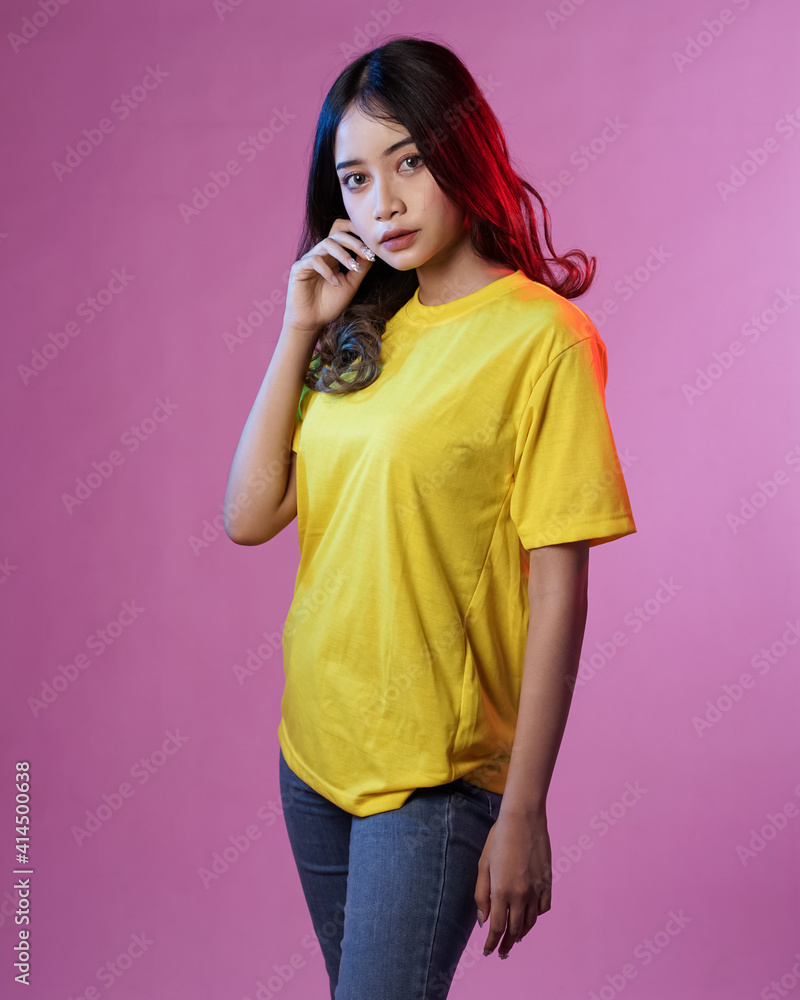 Young female model wearing blank T-shirt in studio background. Woman in ...